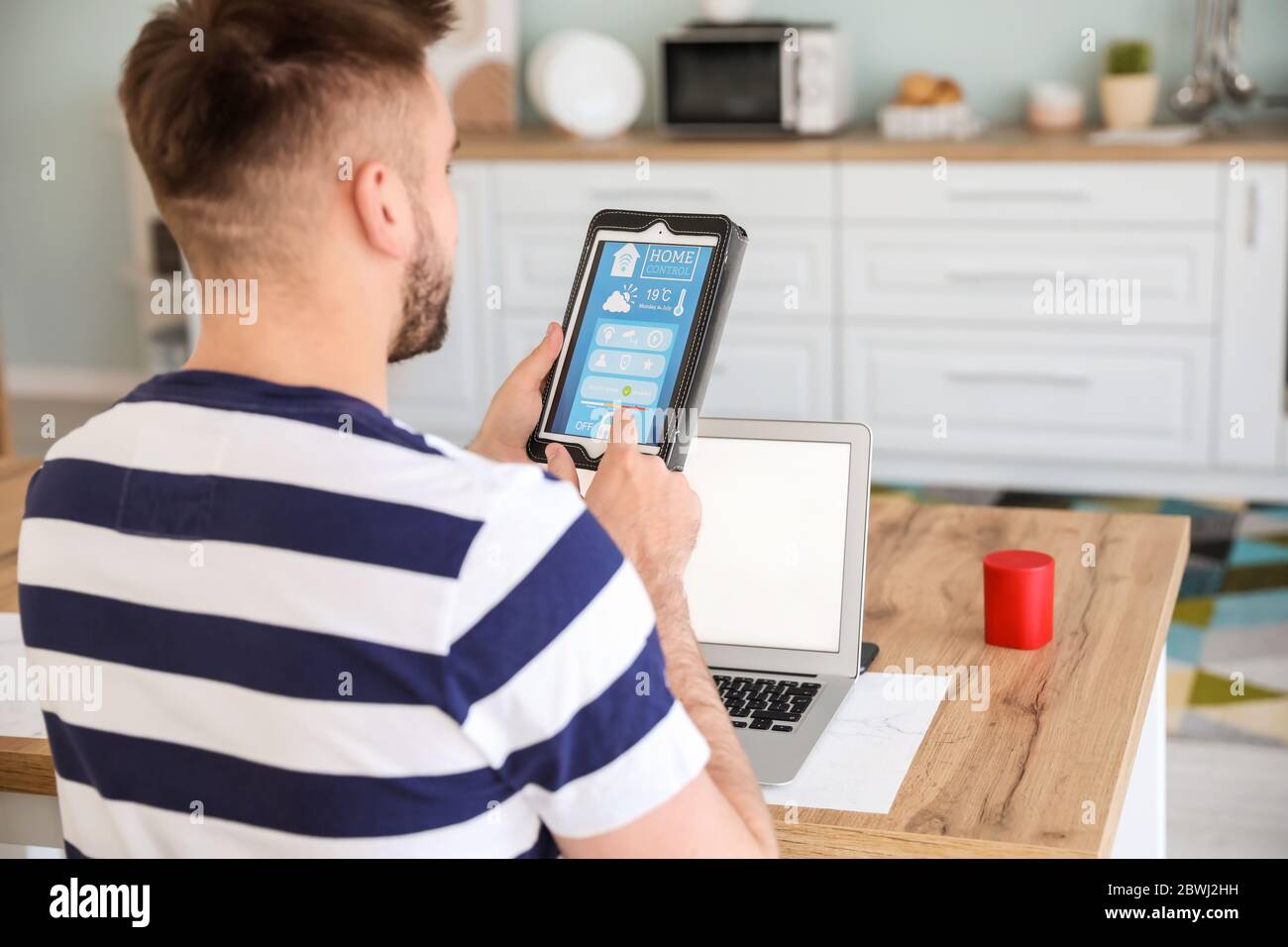Man using application of smart home automation Stock Photo - Alamy