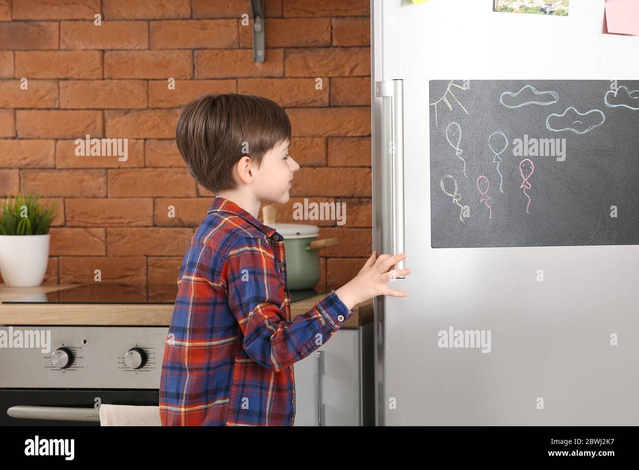 Little boy opening refrigerator in kitchen Stock Photo - Alamy