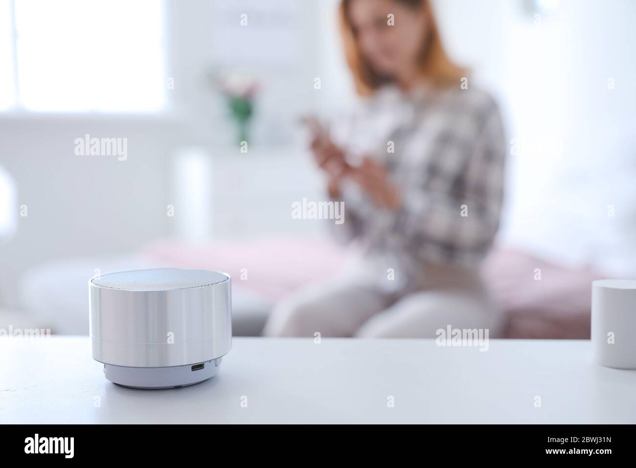 Smart home assistant device on table in bedroom Stock Photo - Alamy