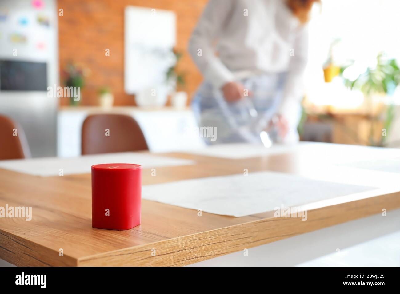 Smart home assistant device on table in kitchen Stock Photo - Alamy