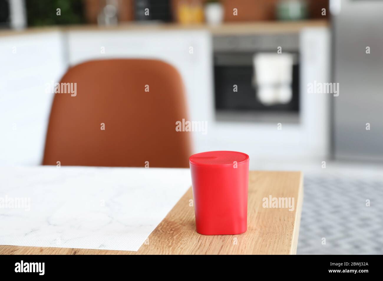 Smart home assistant device on table in kitchen Stock Photo - Alamy