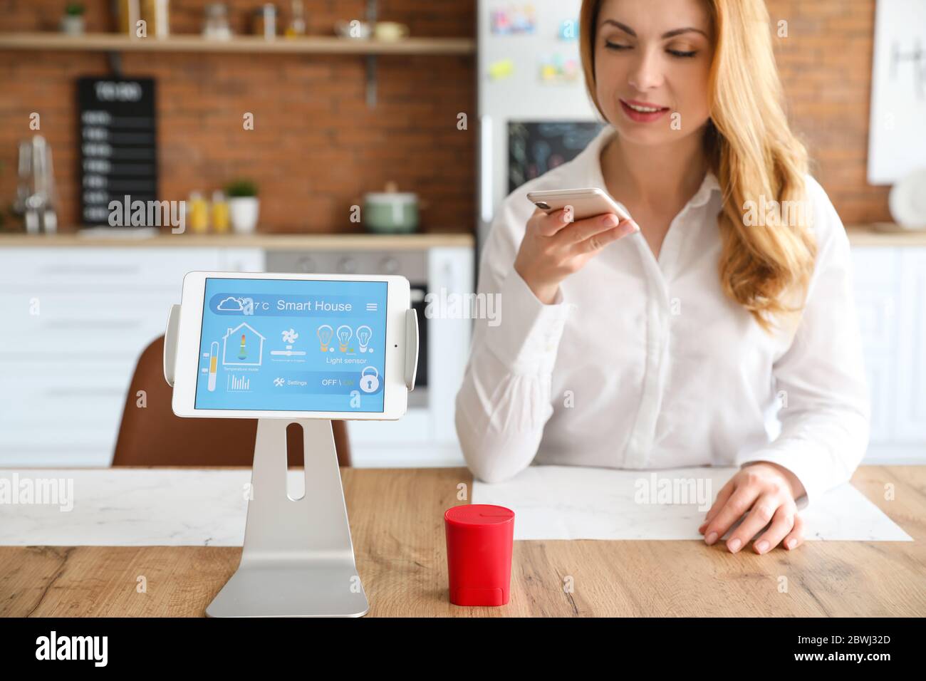 Woman using application of smart home automation Stock Photo - Alamy