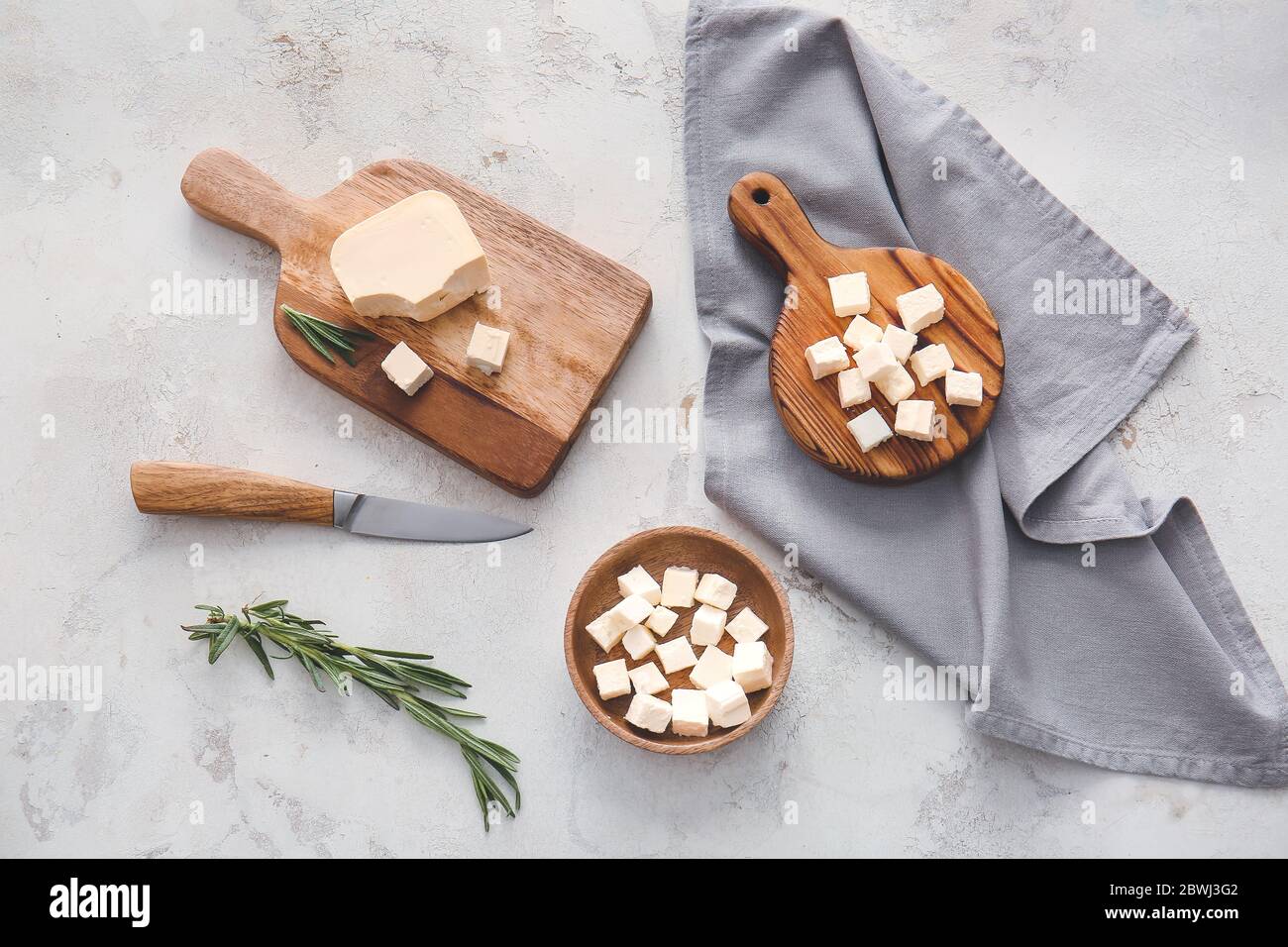 Composition with tasty cut feta cheese on table Stock Photo - Alamy