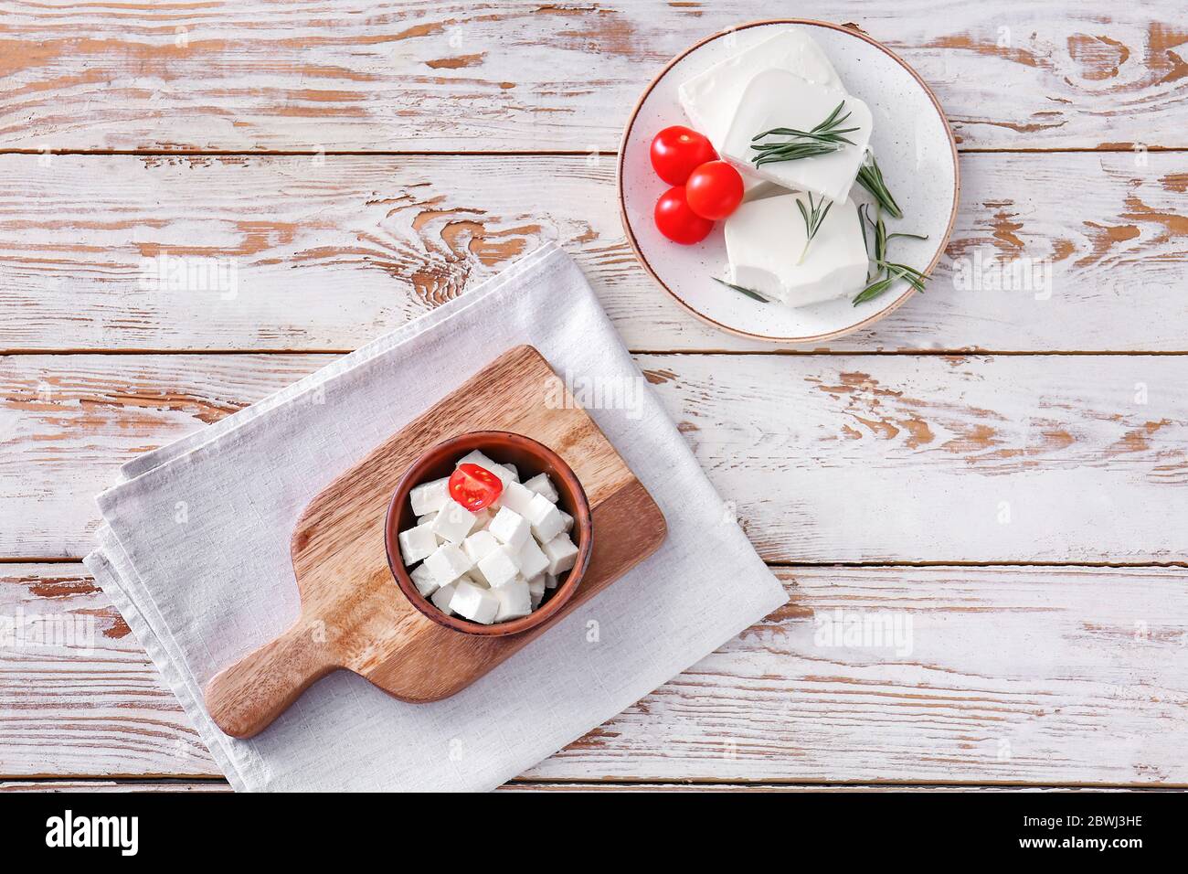 Composition with tasty cut feta cheese on table Stock Photo - Alamy