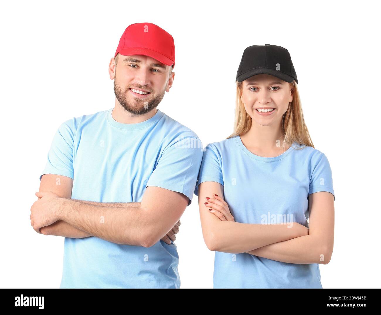 Young couple in stylish caps on white background Stock Photo - Alamy