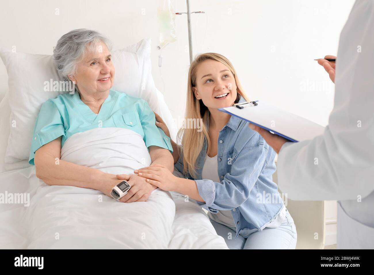Young woman visiting her grandmother in hospital Stock Photo - Alamy