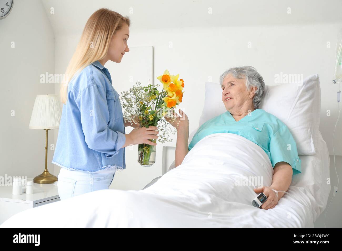 Young woman visiting her grandmother in hospital Stock Photo - Alamy