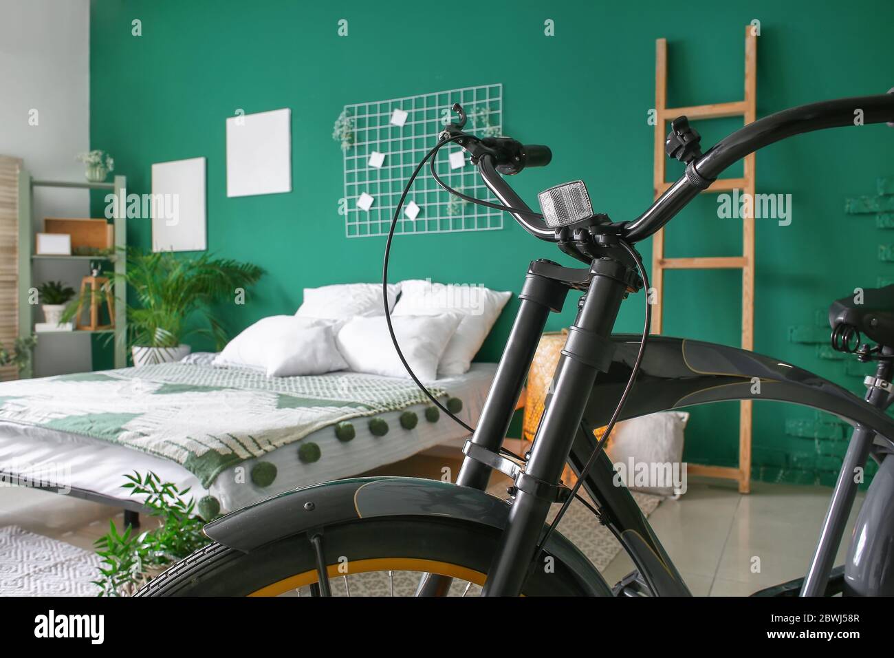 Interior of modern bedroom with bicycle Stock Photo - Alamy