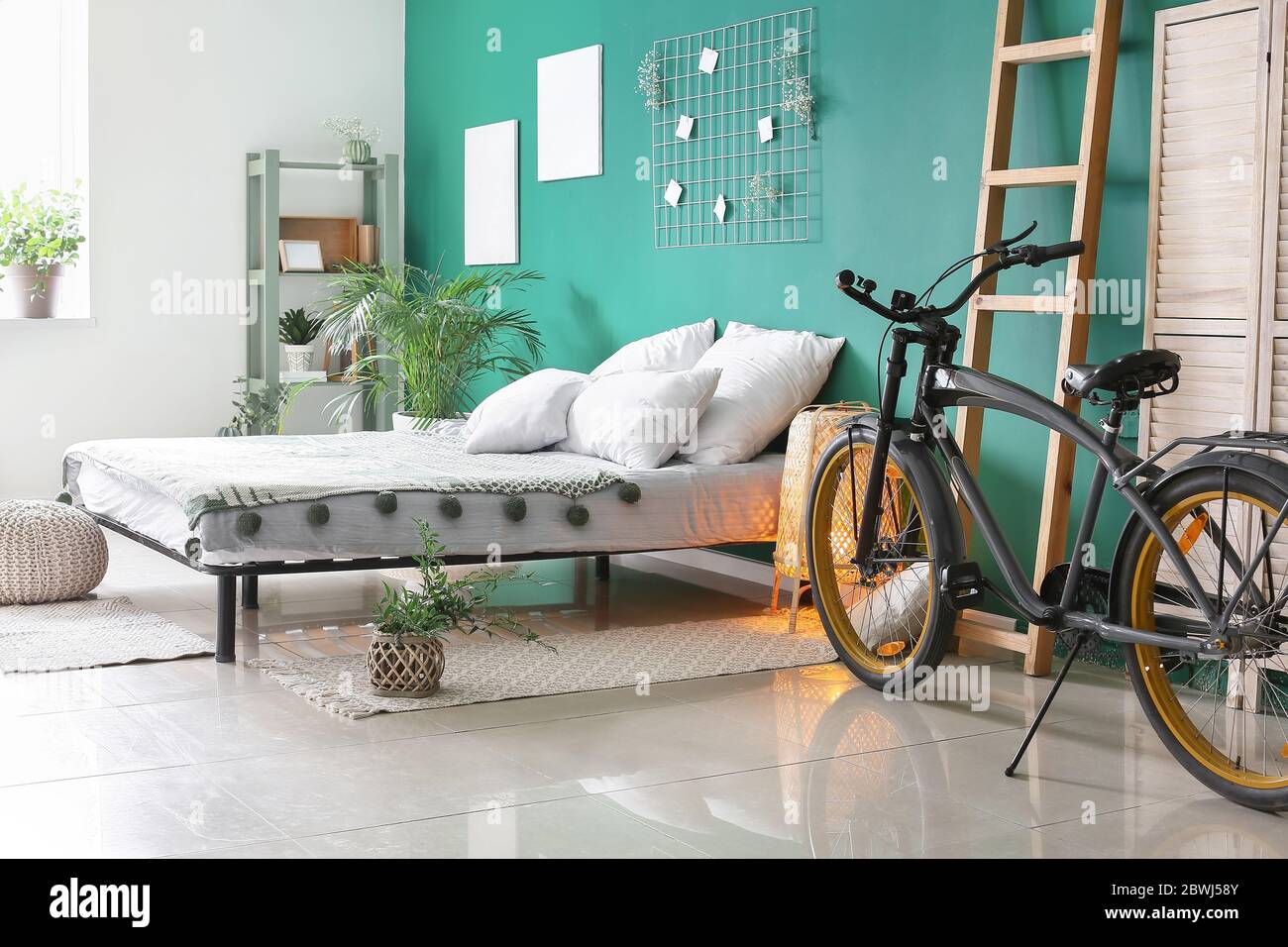 Interior of modern bedroom with bicycle Stock Photo - Alamy