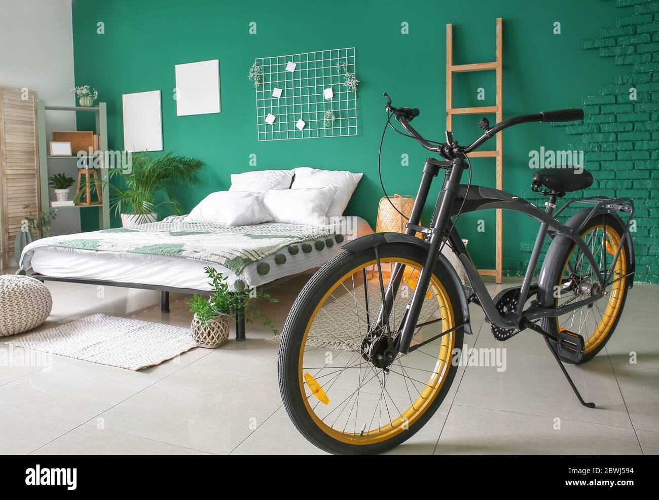 Interior of modern bedroom with bicycle Stock Photo - Alamy