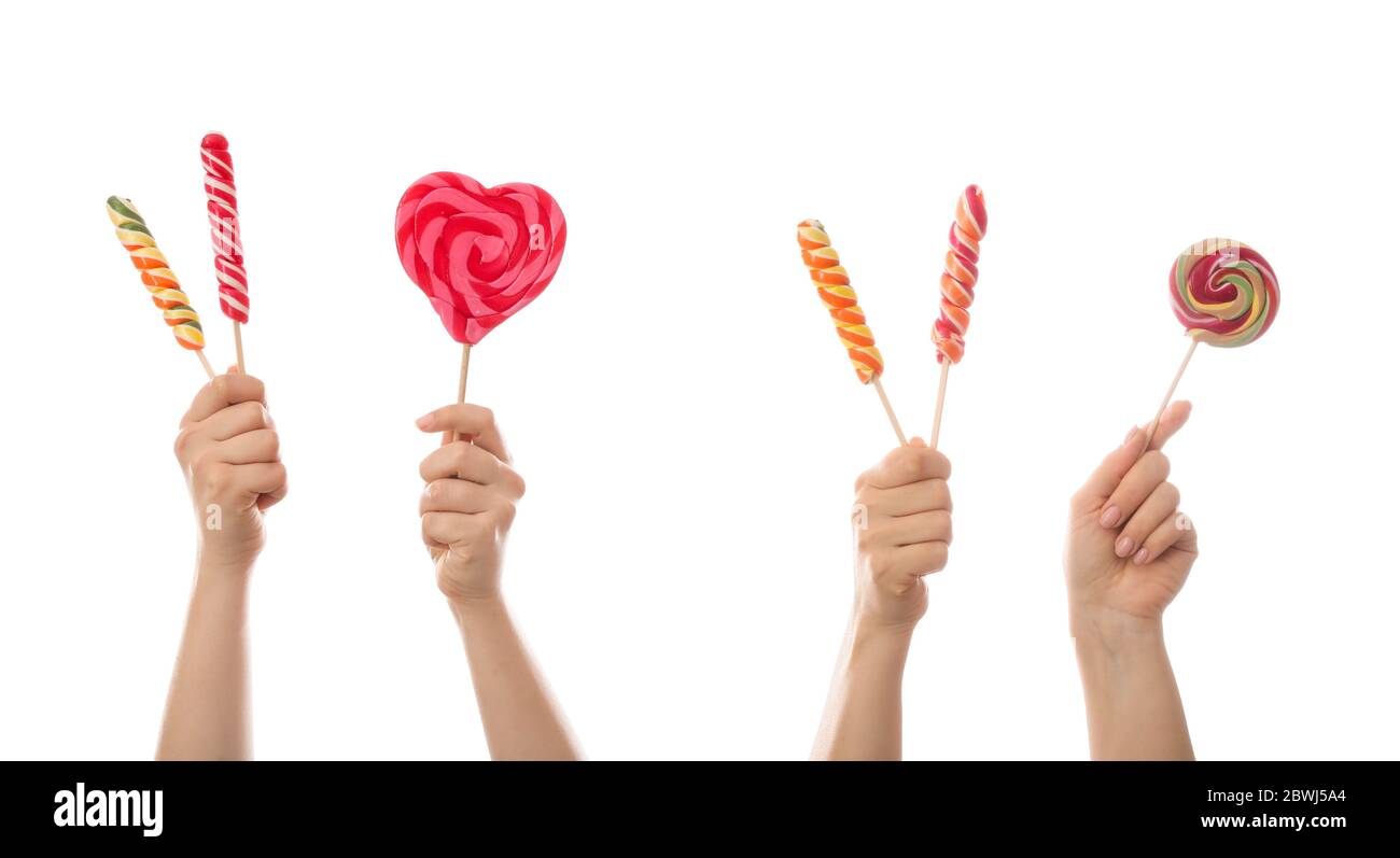 Hands with sweet lollipops on white background Stock Photo - Alamy