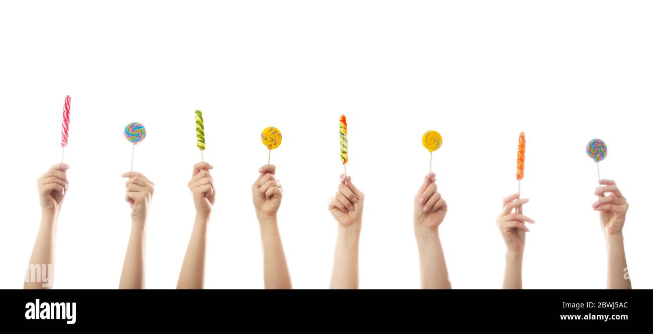 Hands with sweet lollipops on white background Stock Photo - Alamy