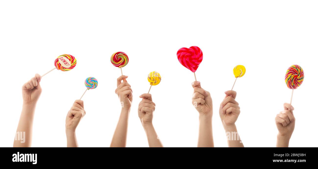 Hands with sweet lollipops on white background Stock Photo - Alamy