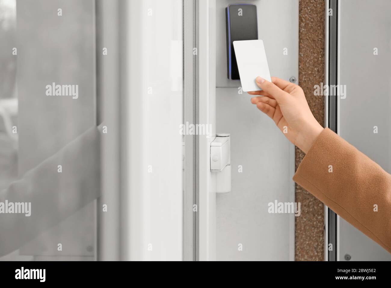 Woman opening door with security card from the outside Stock Photo - Alamy