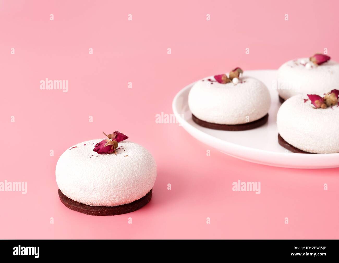 Mousse pastry dessert covered with white chocolate and decorated with ...