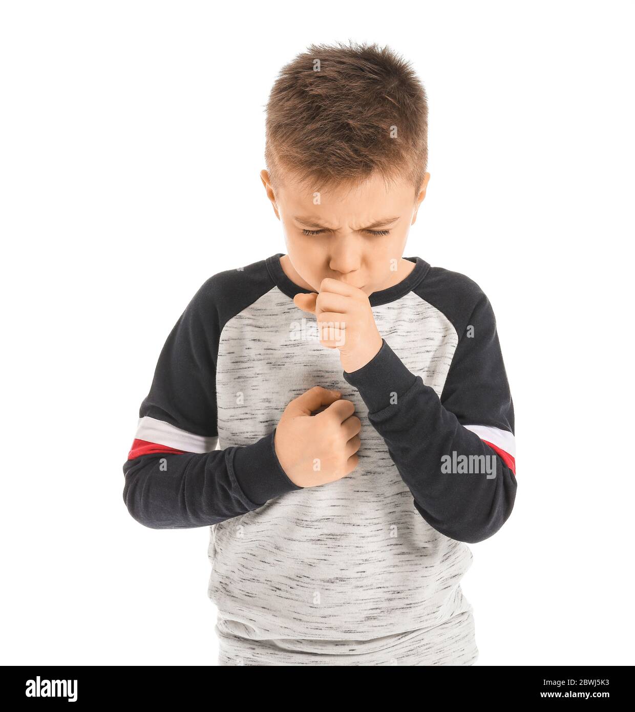 Ill coughing little boy on white background Stock Photo - Alamy