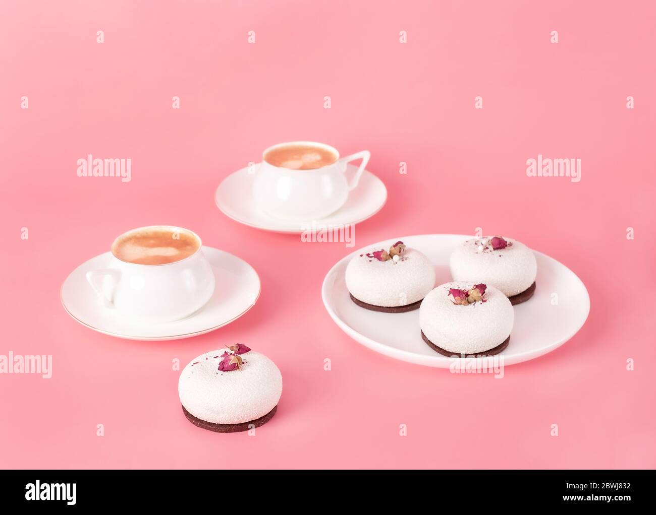 Mousse pastry dessert covered with white chocolate decorated with rose ...