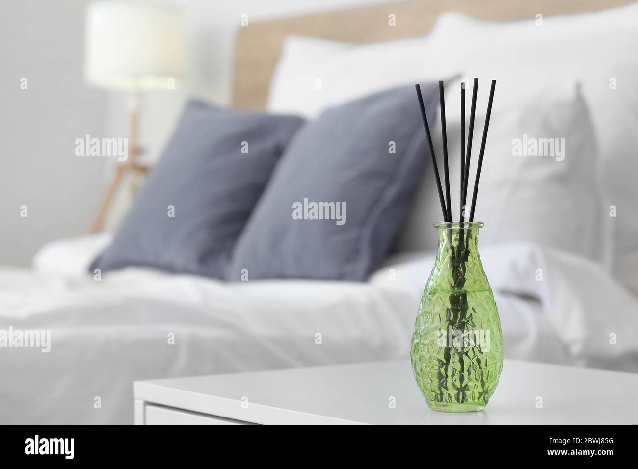 Reed diffuser on table in bedroom Stock Photo - Alamy