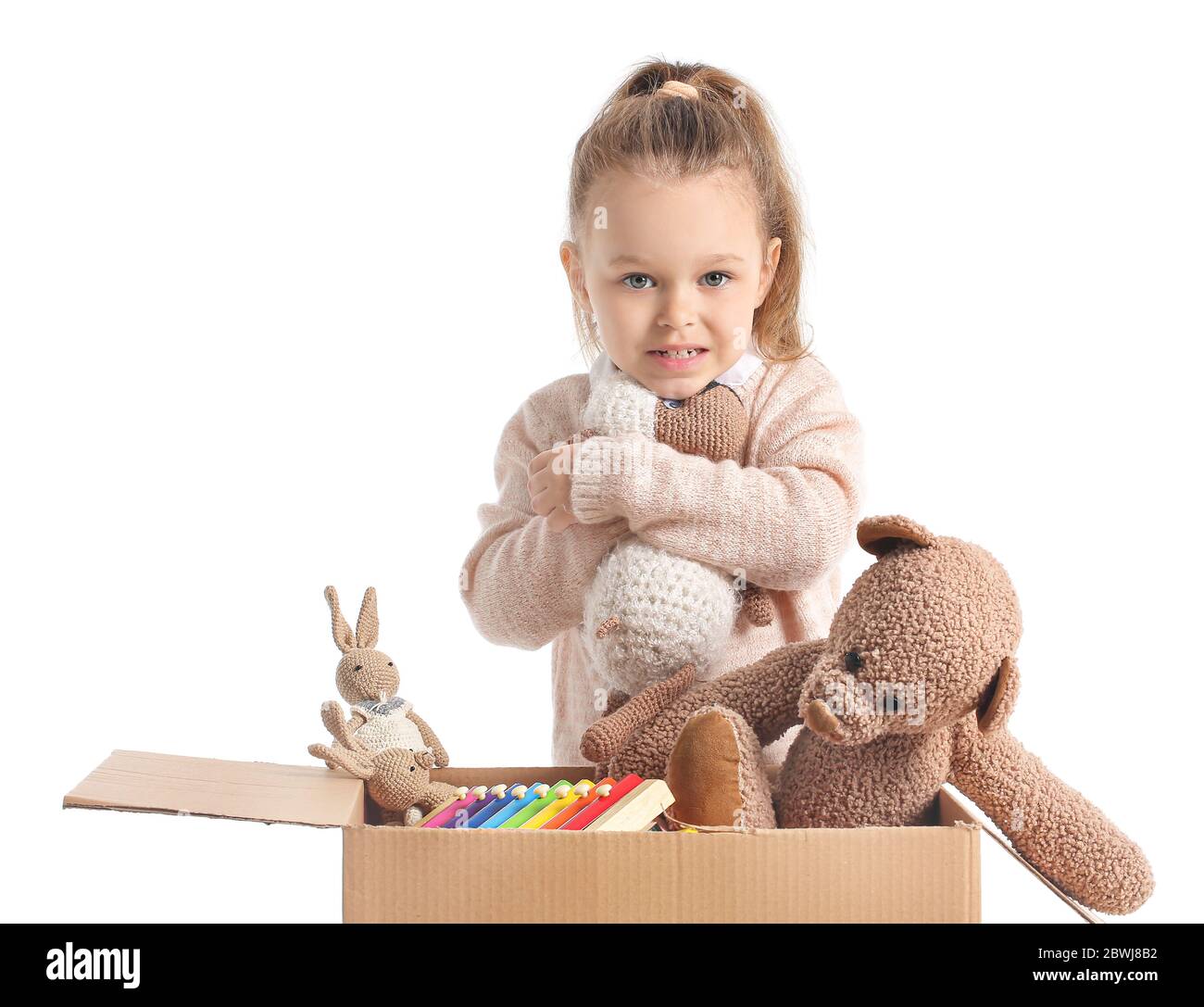 Little girl with toys on white background Stock Photo - Alamy