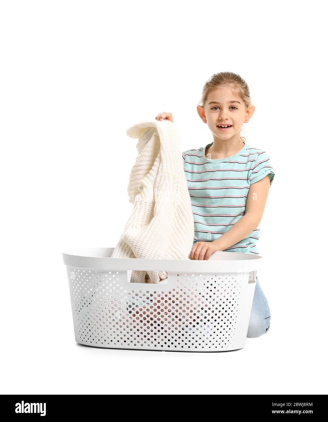Little girl with laundry on white background Stock Photo - Alamy