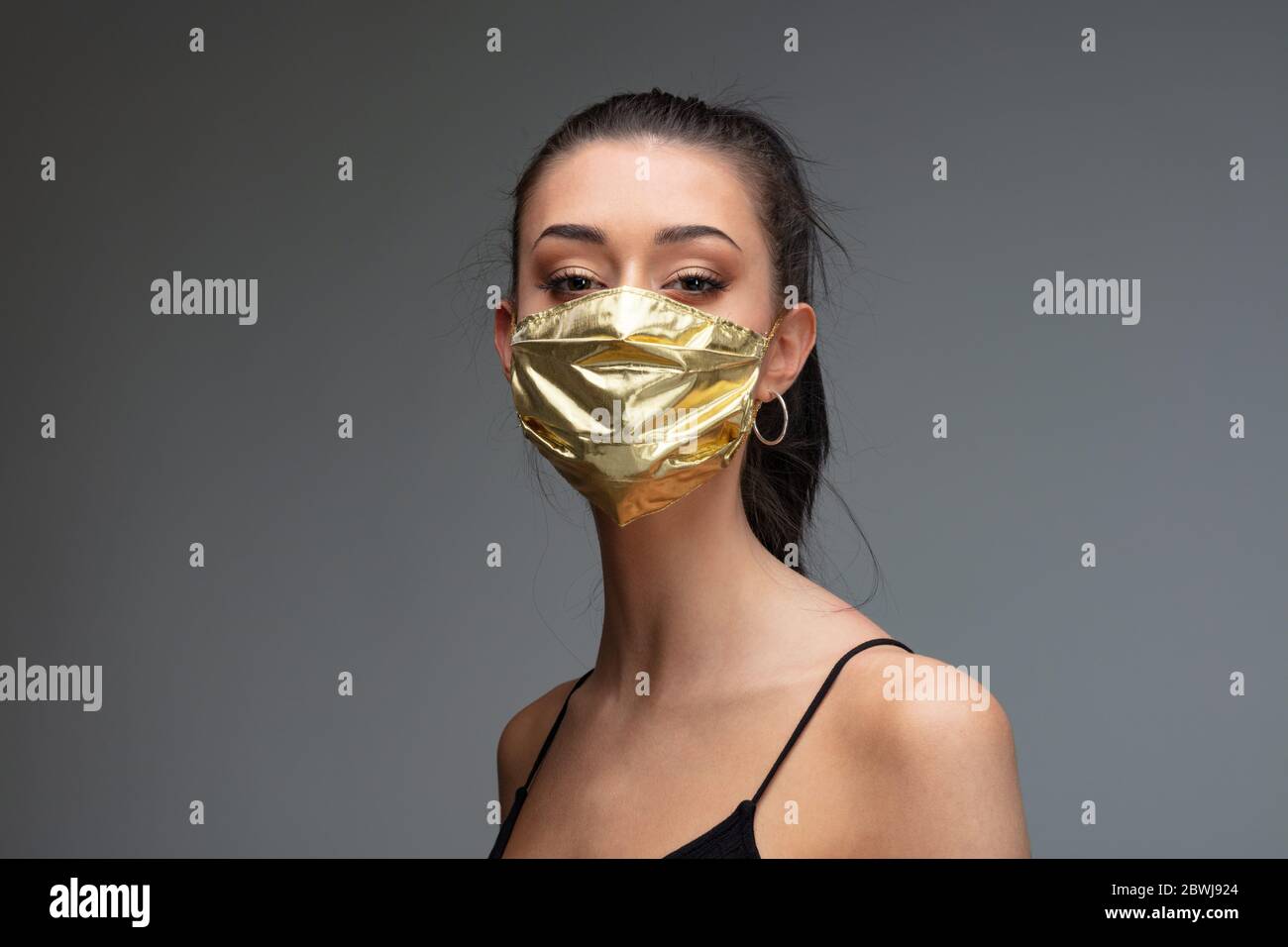 haughty woman wearing a golden face mask - concept of surgical masks ...