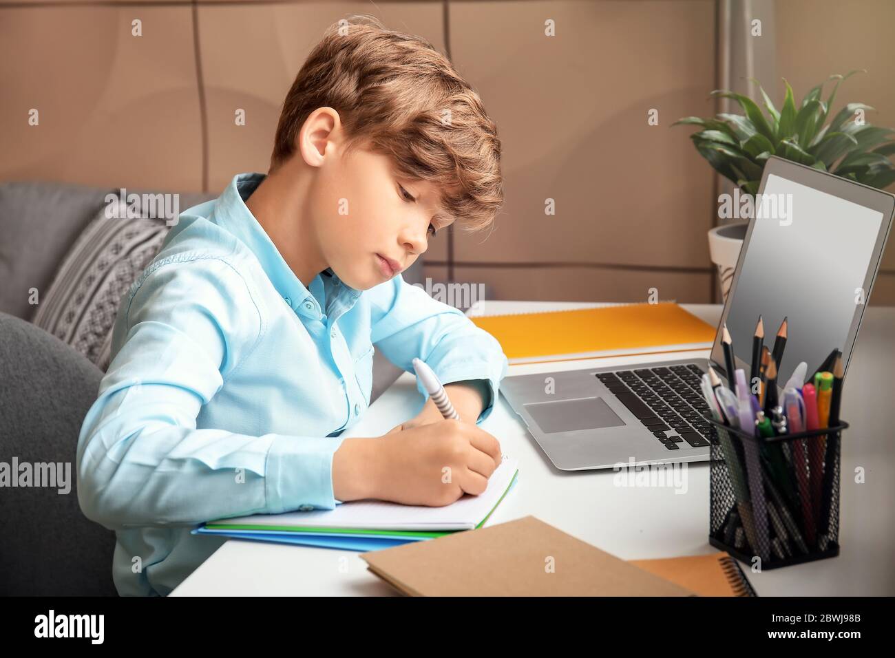Cute little boy studying at home. Concept of online education Stock ...