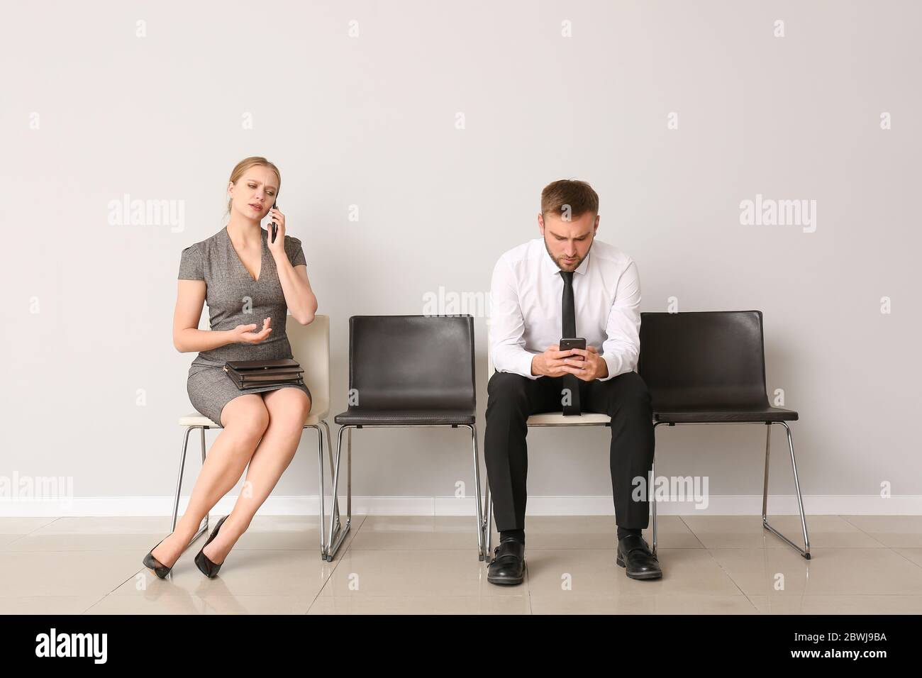 Business people waiting in line indoors Stock Photo - Alamy