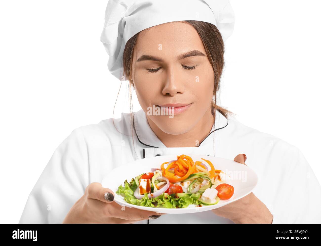 Transgender chef with salad on white background Stock Photo - Alamy
