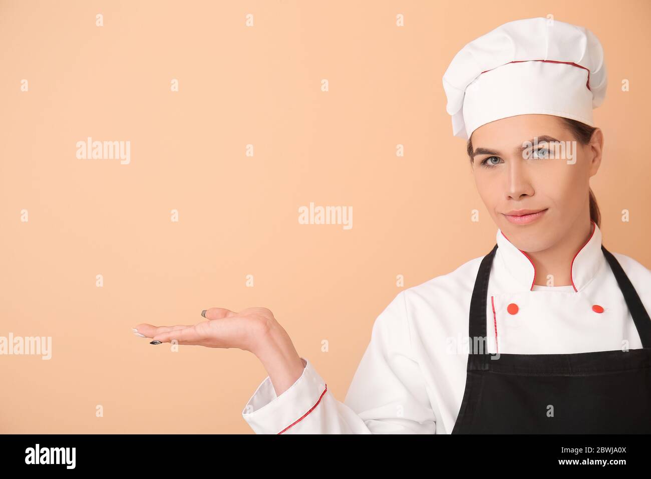 Transgender chef showing something on color background Stock Photo - Alamy