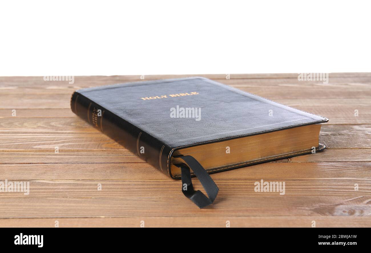 Holy Bible on table against white background Stock Photo - Alamy