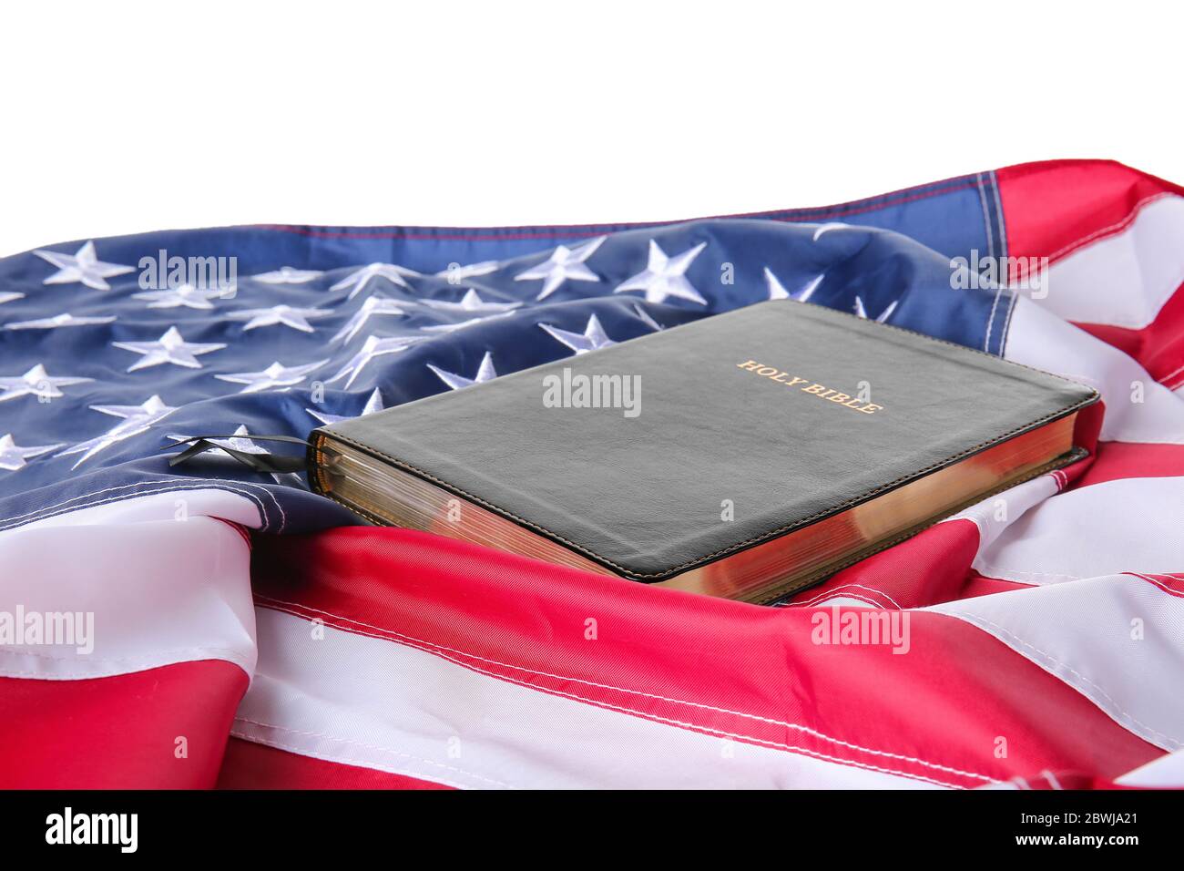Holy Bible and USA flag on white background Stock Photo - Alamy