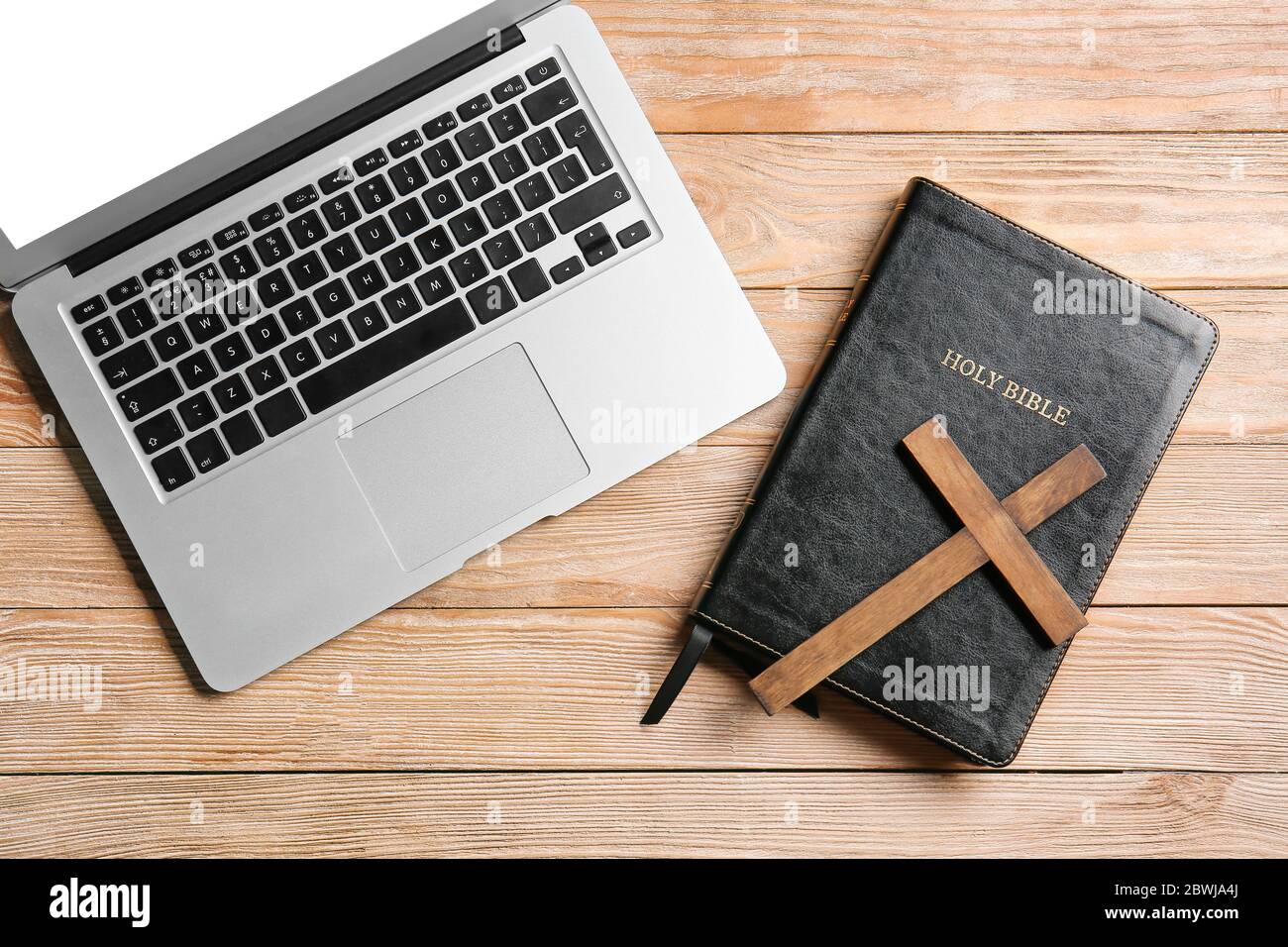 Holy Bible, laptop and cross on wooden background Stock Photo - Alamy