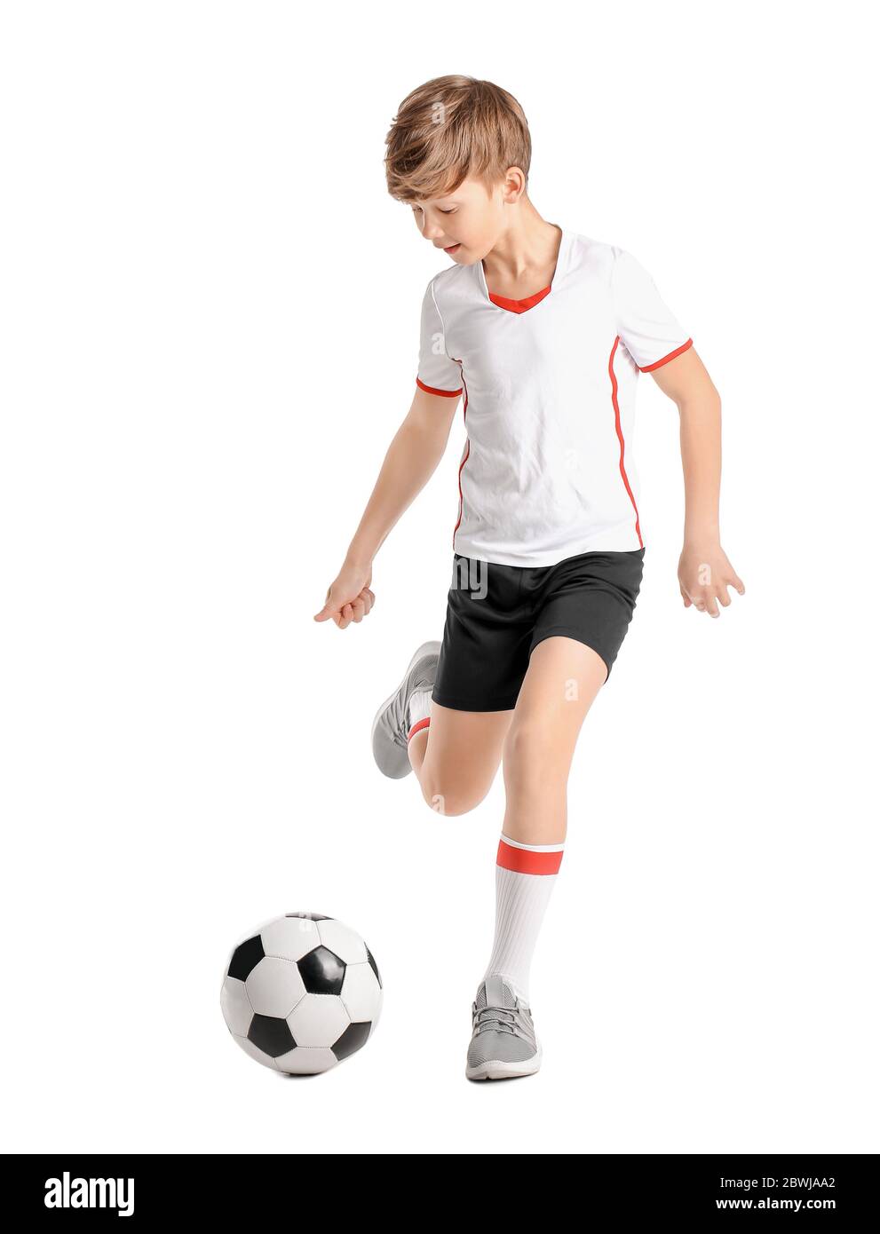 Cute little football player on white background Stock Photo - Alamy