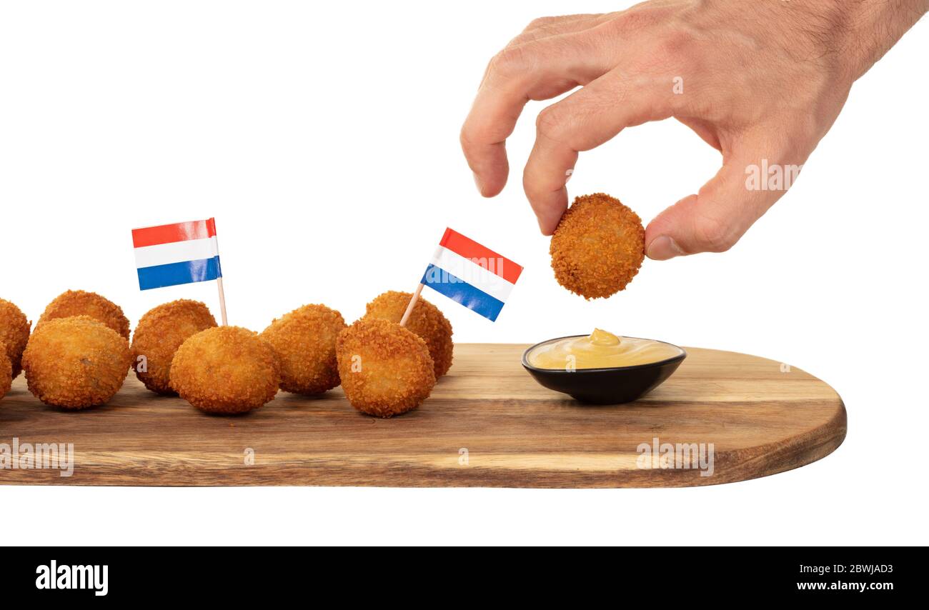 Dutch traditional snack bitterbal in a hand, isolated Stock Photo - Alamy