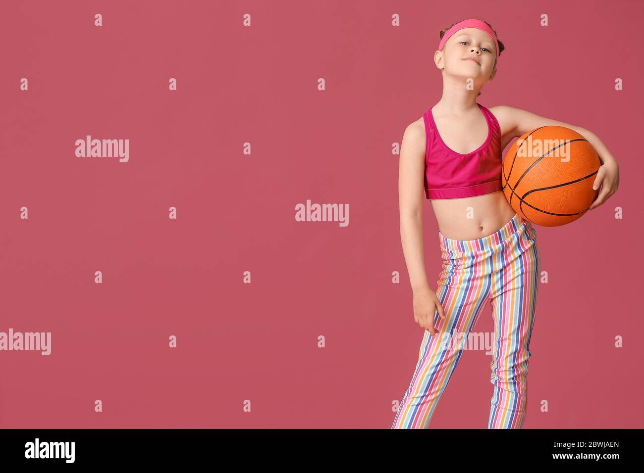 Cute little basketball player on color background Stock Photo - Alamy