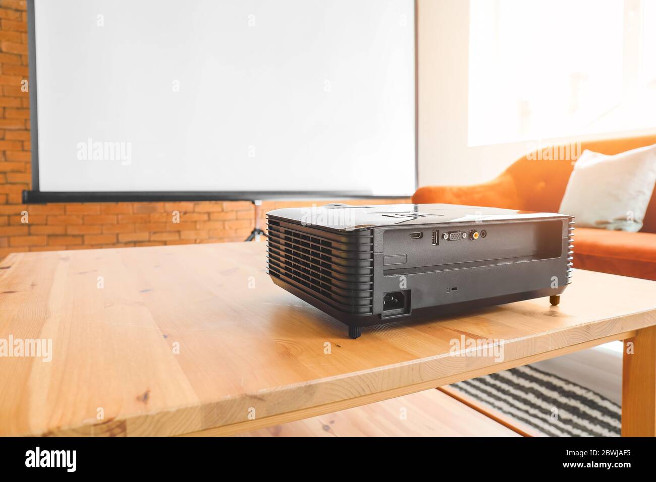 Modern video projector on table in room Stock Photo - Alamy