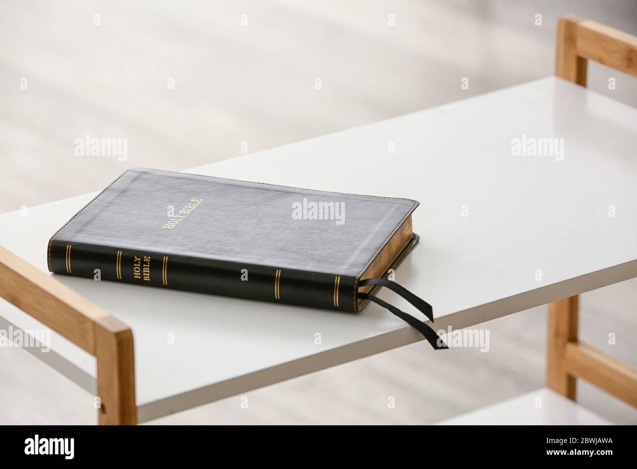 Holy Bible on table in room Stock Photo - Alamy
