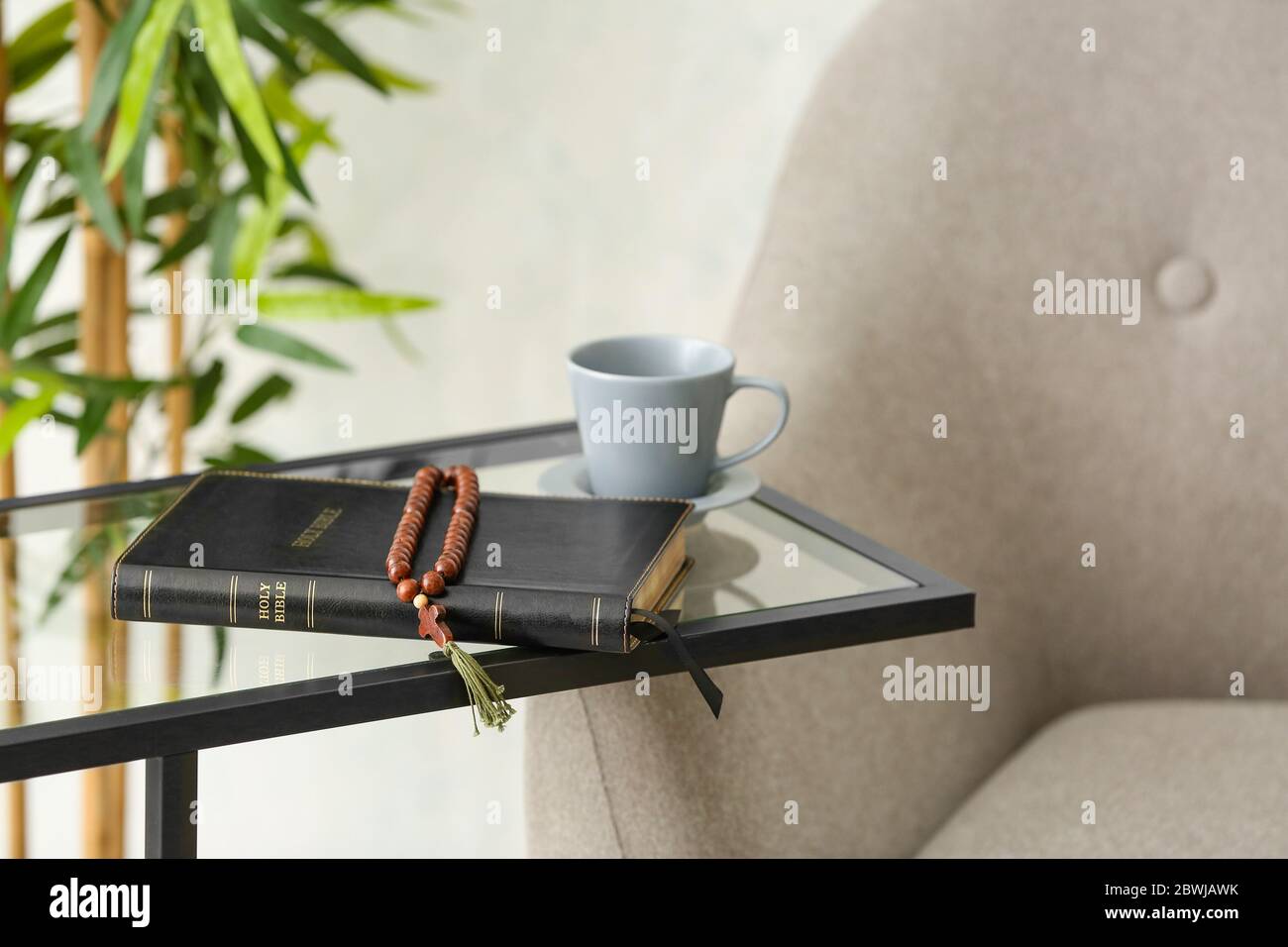Holy Bible on table in room Stock Photo - Alamy