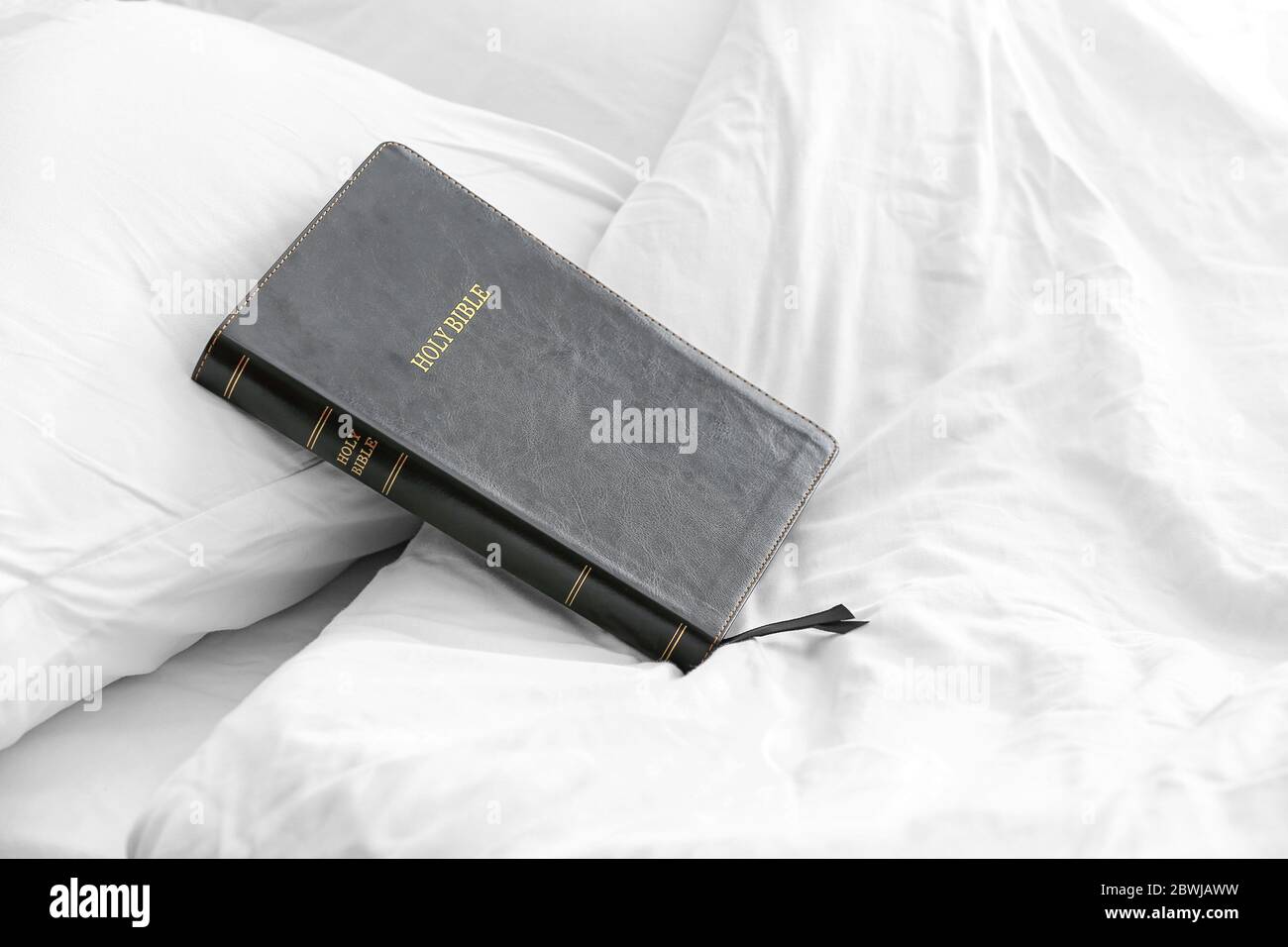 Holy Bible on bed in room Stock Photo - Alamy