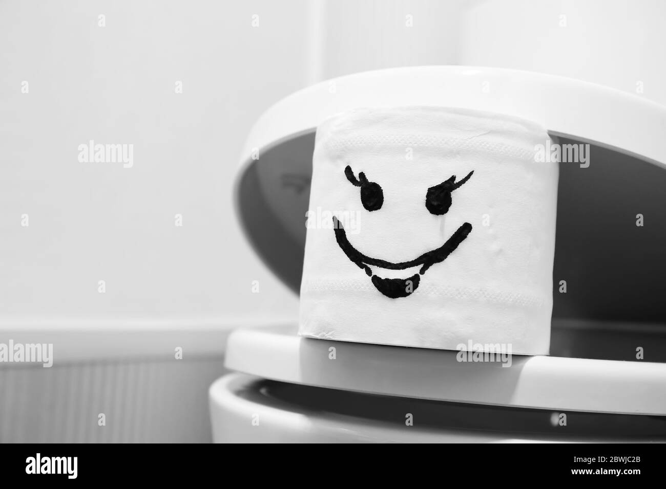 Roll of toilet paper with drawn face in restroom Stock Photo - Alamy