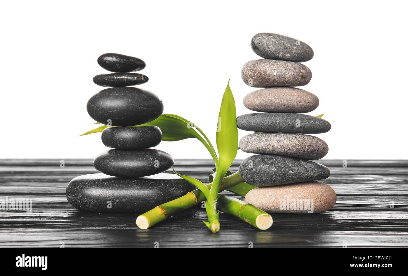 Zen stones and bamboo on table against white background Stock Photo - Alamy