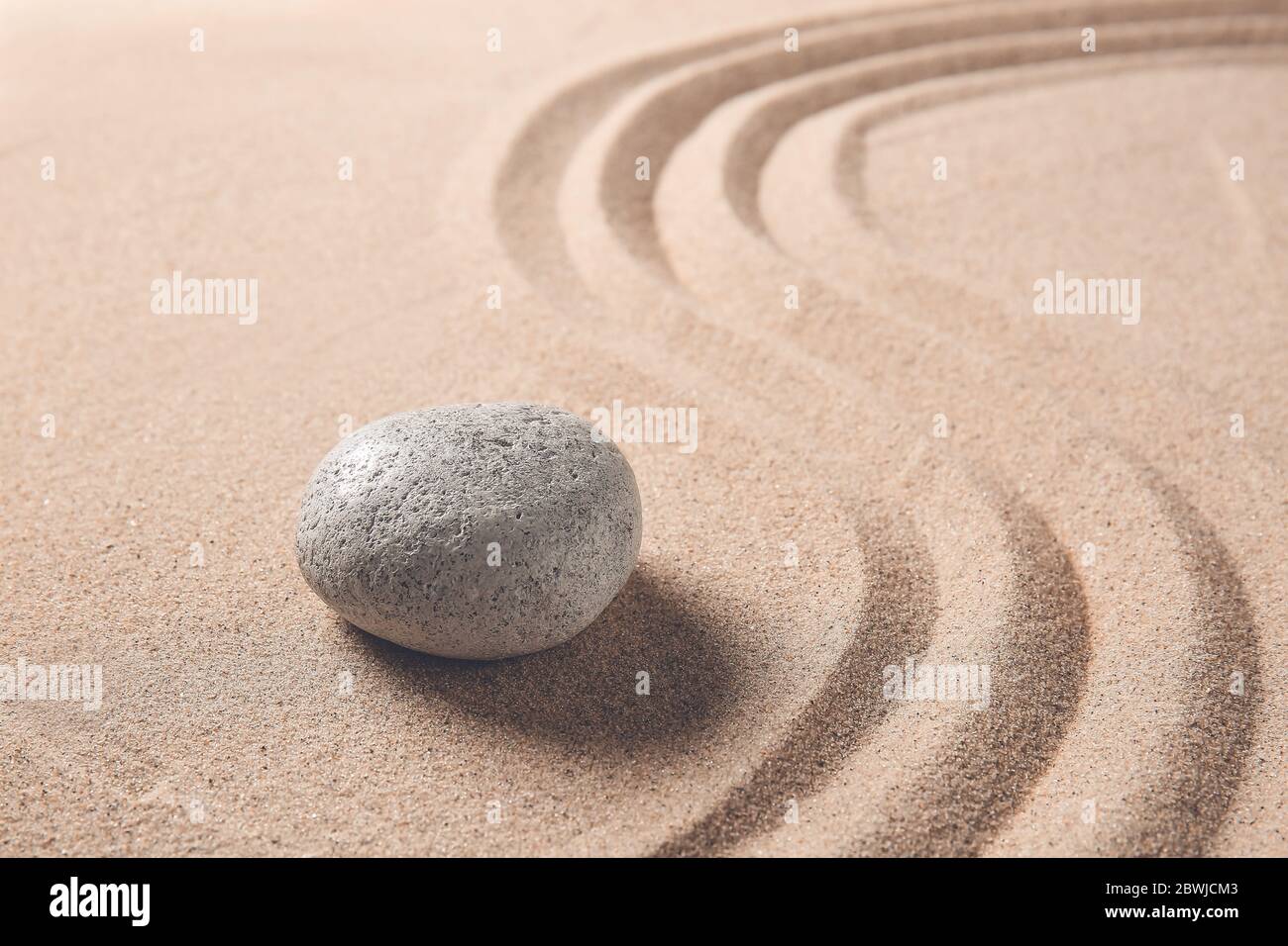 Stone on sand with lines. Zen concept Stock Photo - Alamy