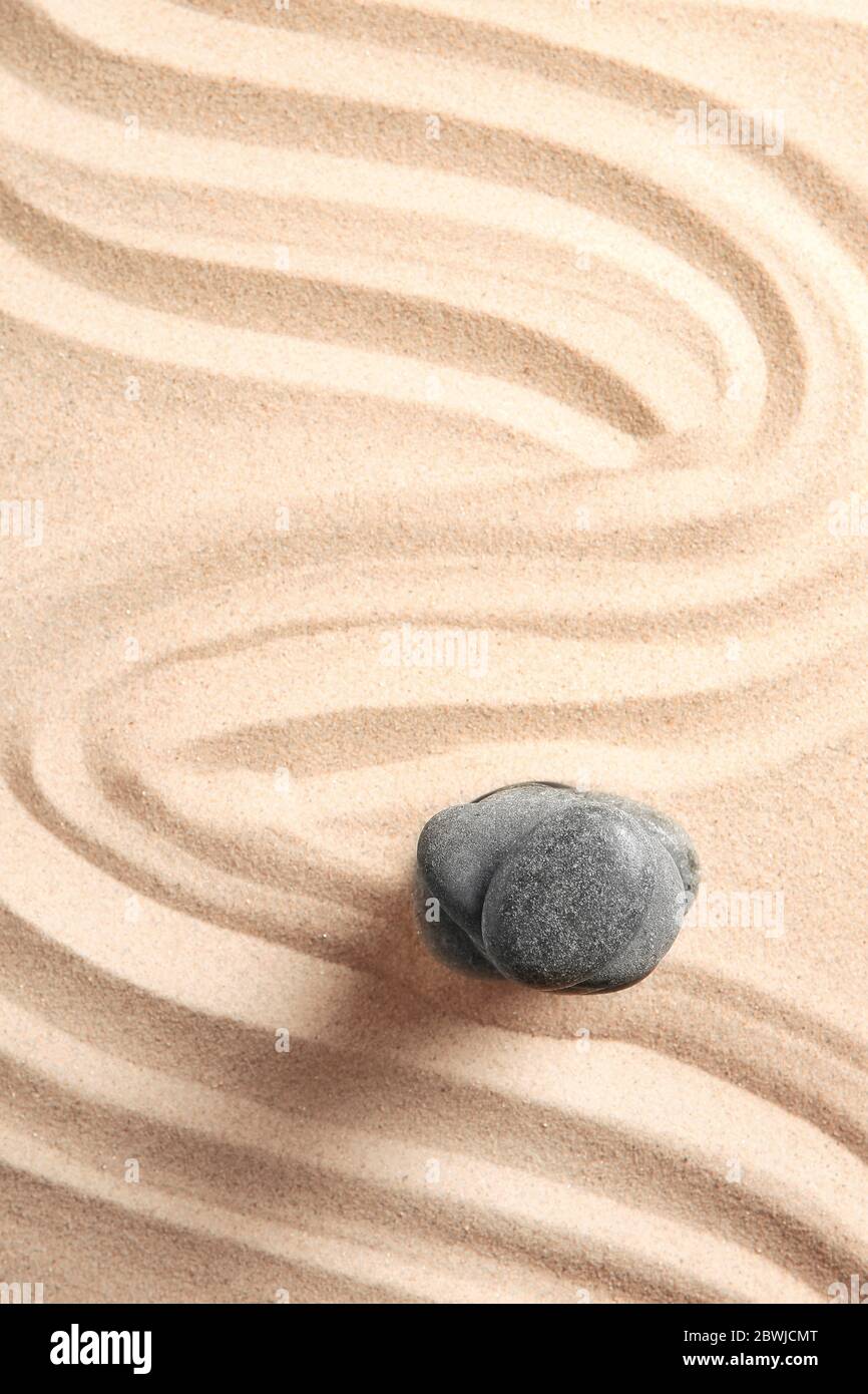 Stones on sand with lines. Zen concept Stock Photo - Alamy