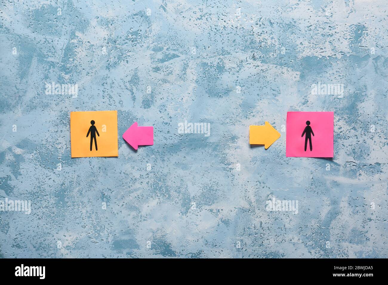 Paper sheets with drawn human figures and arrows on color background ...