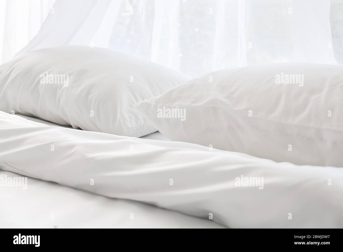 Soft white linen on bed Stock Photo - Alamy