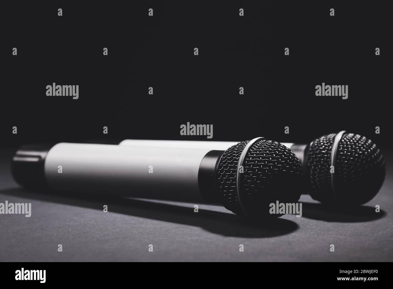 Modern microphones on dark background Stock Photo - Alamy
