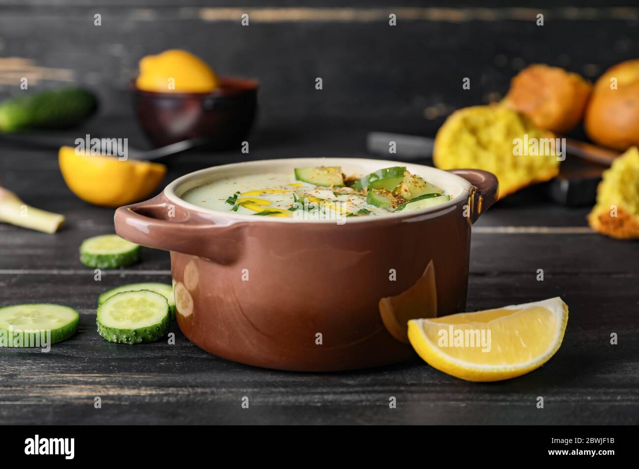 Pot with cold cucumber soup on table Stock Photo - Alamy