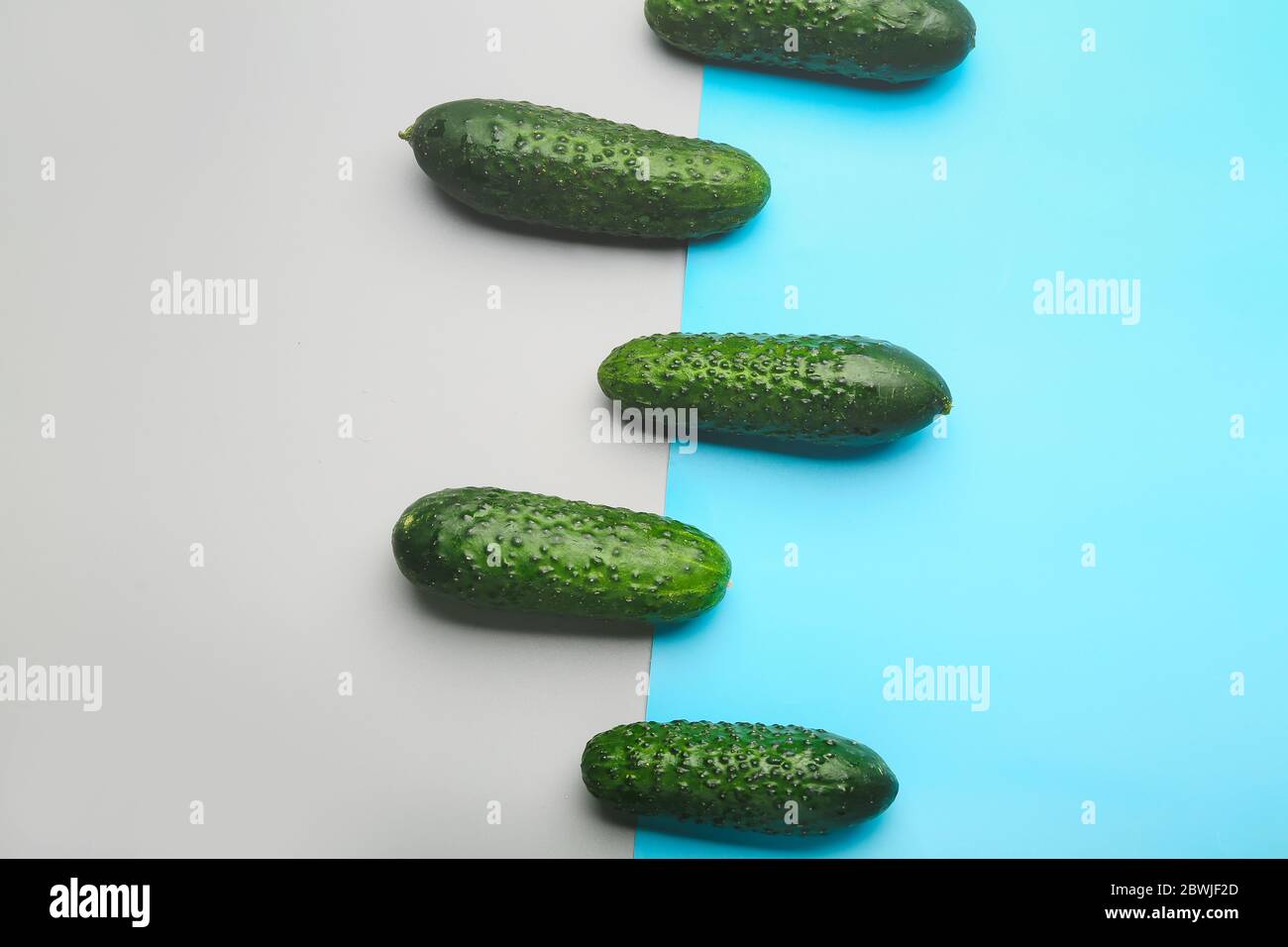 Fresh green cucumbers on color background Stock Photo - Alamy