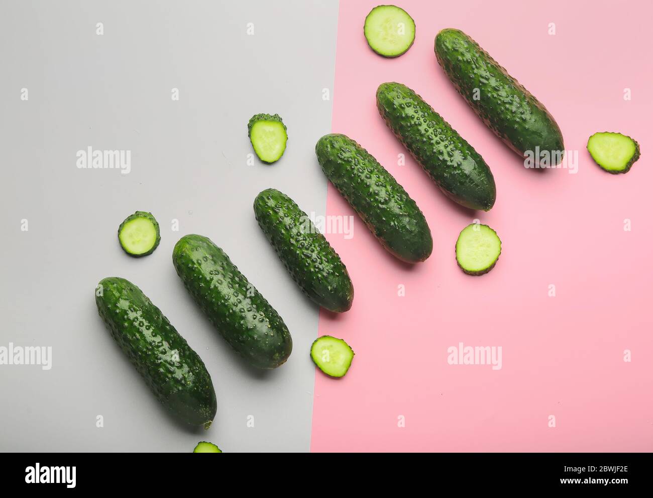 Fresh green cucumbers on color background Stock Photo - Alamy