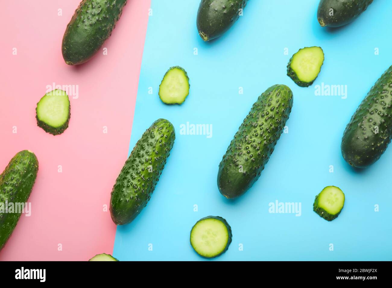 Fresh green cucumbers on color background Stock Photo - Alamy